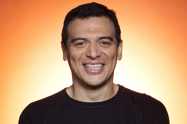 Why did Carlos Mencia face 12 felony charges?