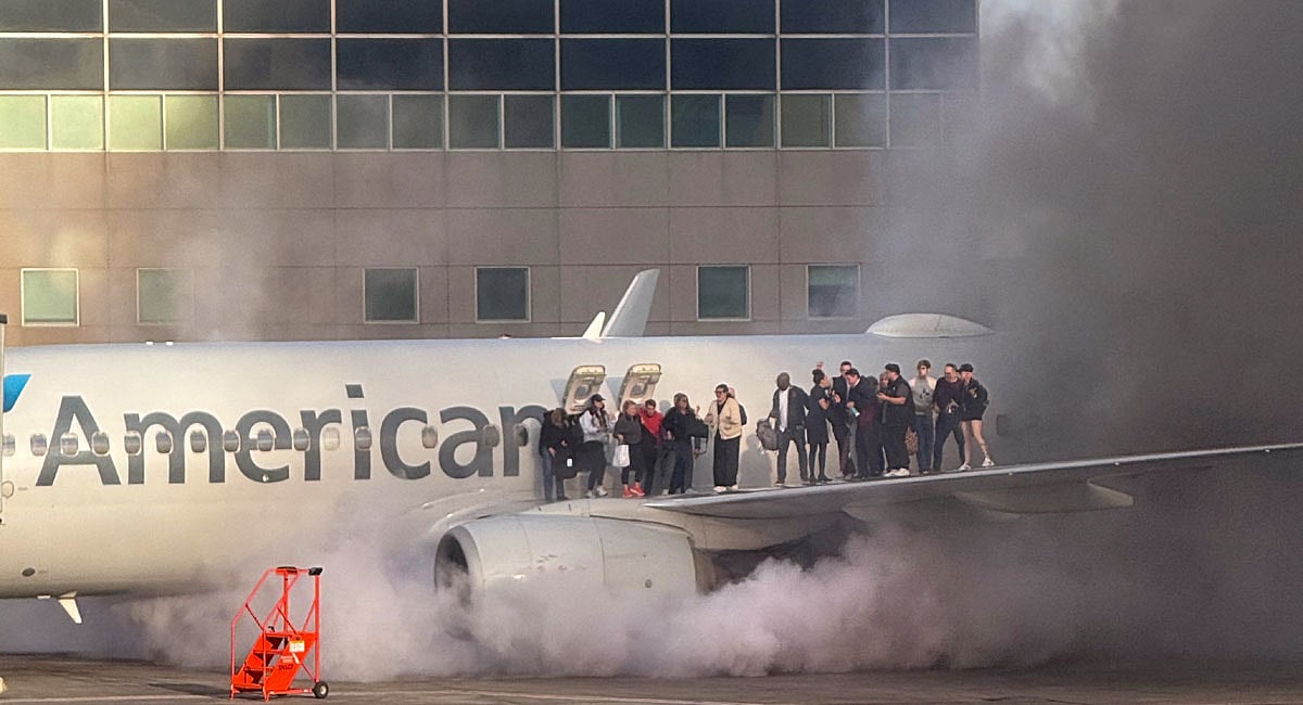 12 taken to hospitals after American Airlines plane catches fire at ...