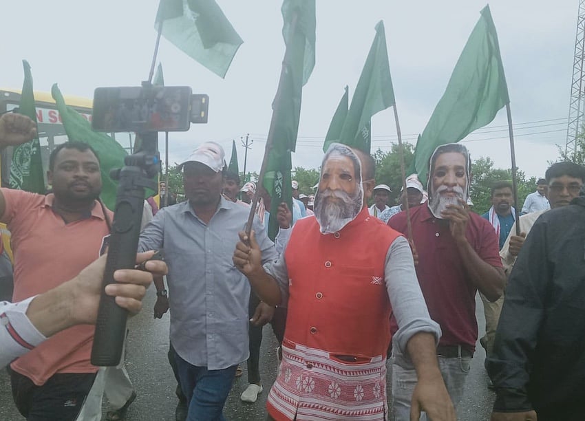 Farmers wearing Shibu Soren masks plough land in protest against RIMS-2 ...